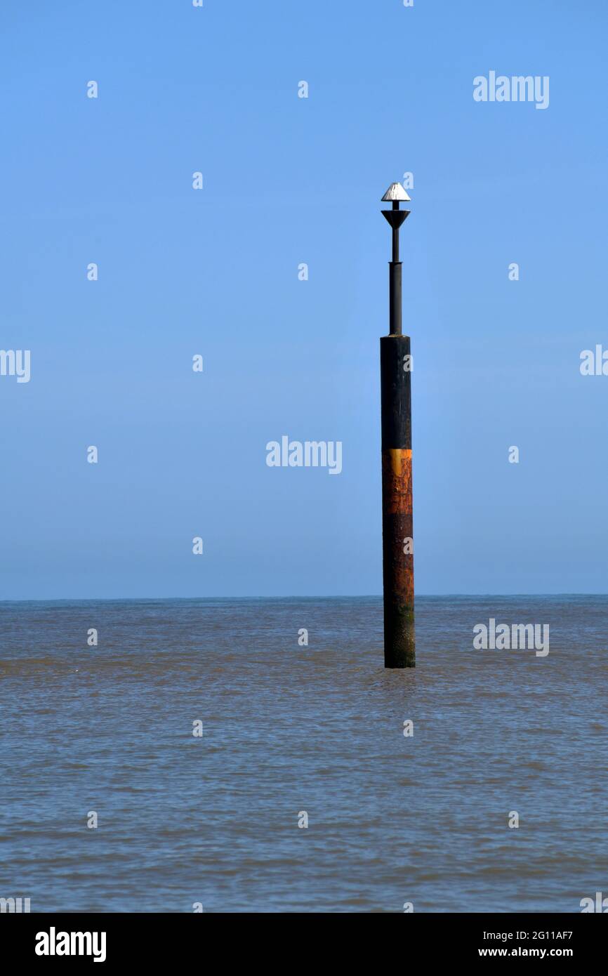 single marker post in sea just off shoreline winterton on sea beach ...