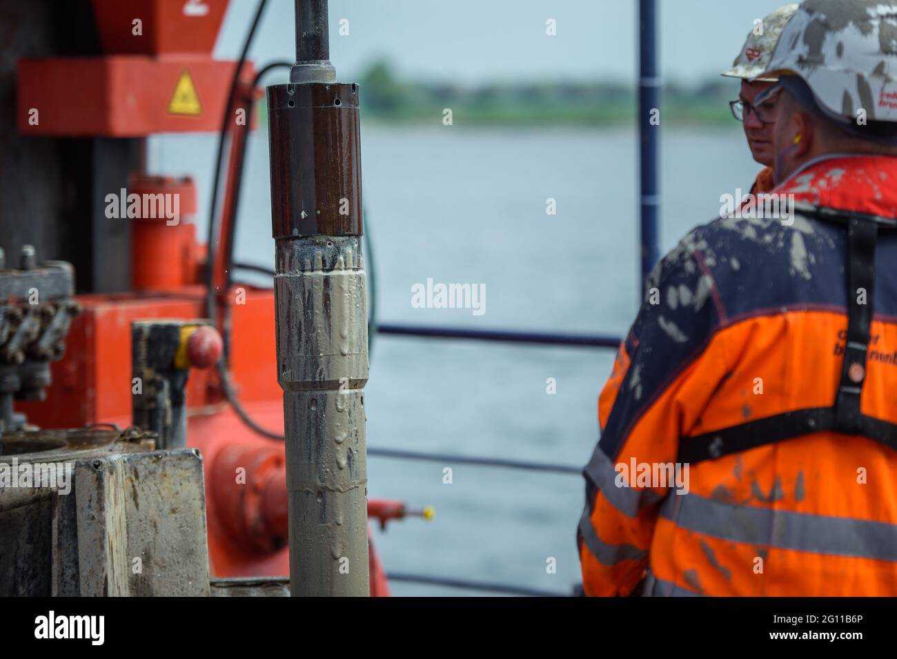 Fehmarn, Germany. 04th June, 2021. Workers on a drilling rig watch as ...