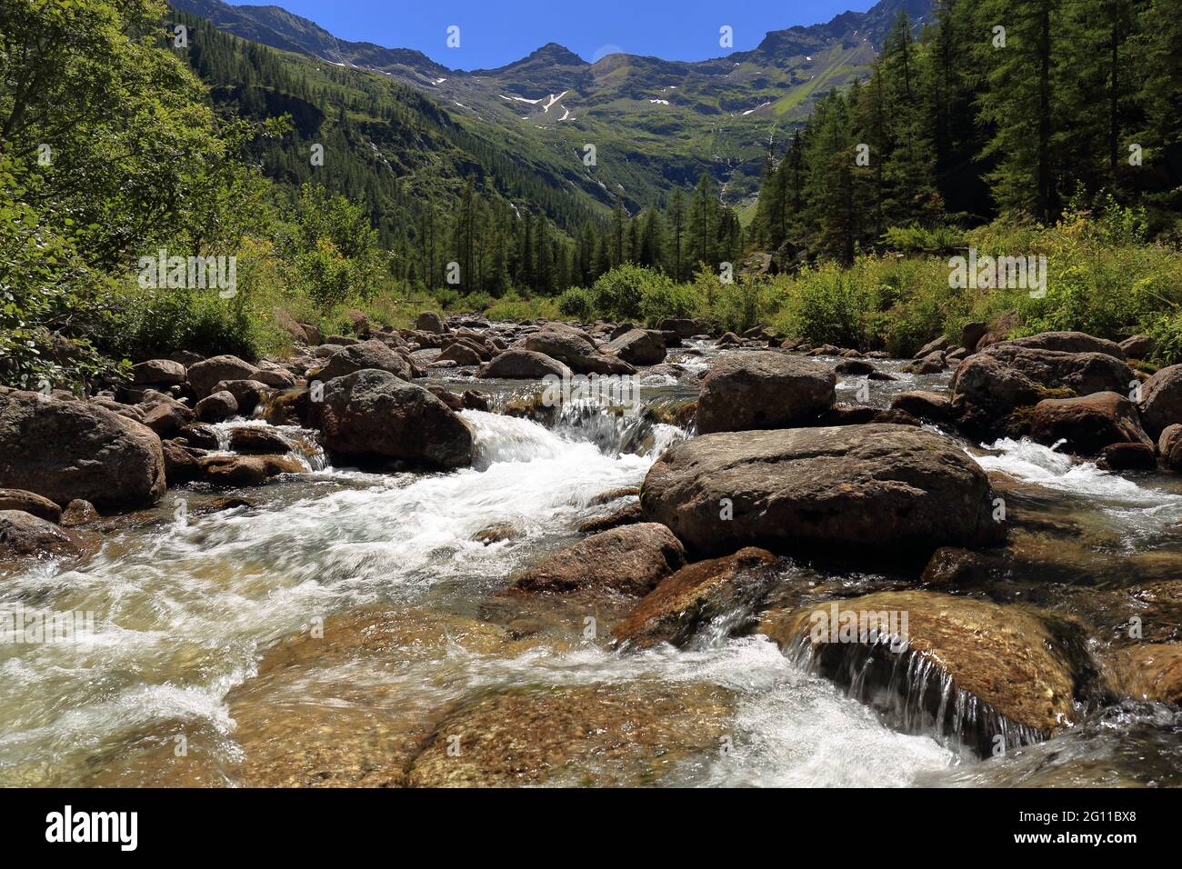 High mountain river with mountains background Stock Photo - Alamy