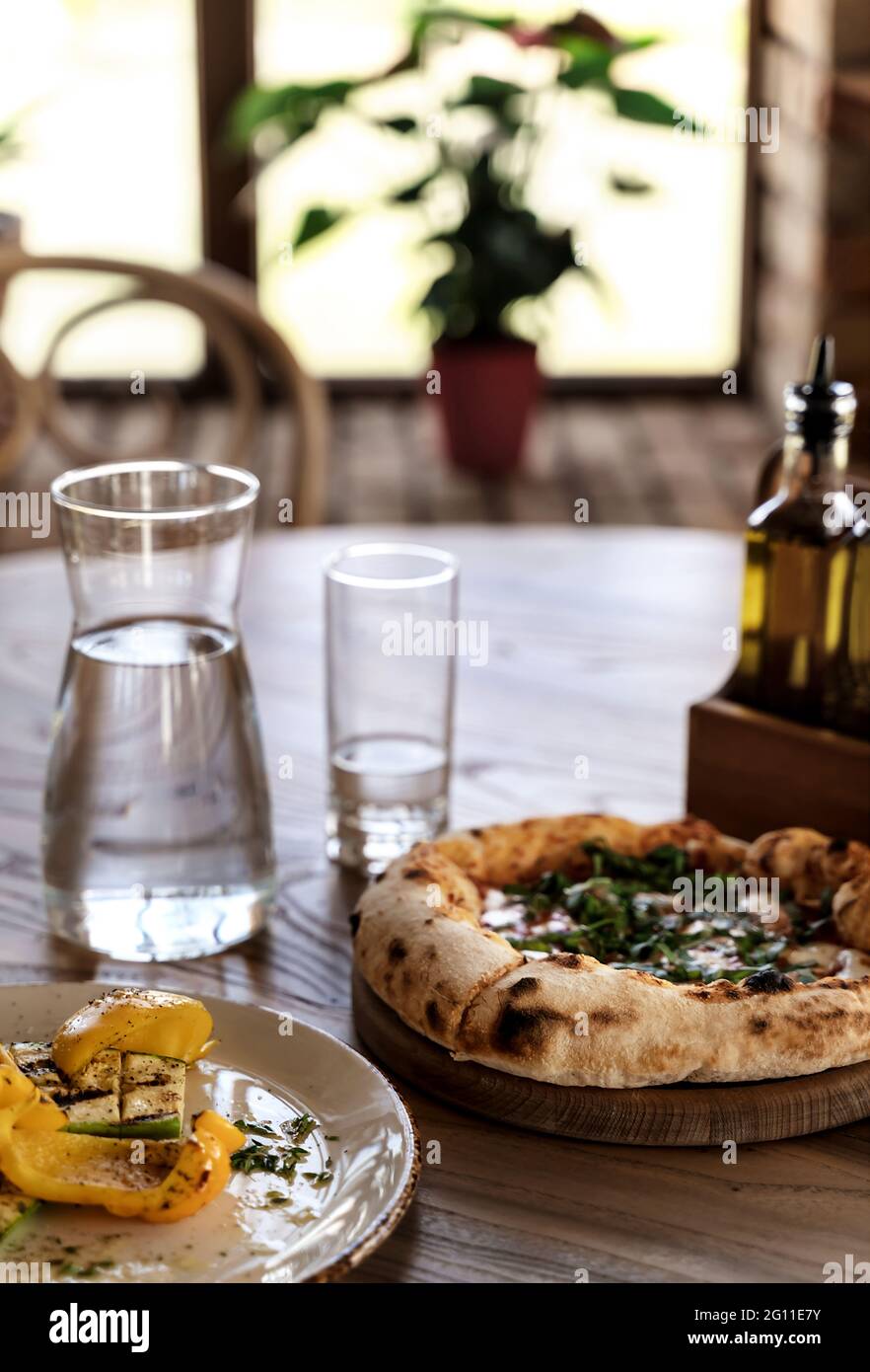 Pizza and grilled vegetables on wooden table in vintage style. Italian ...