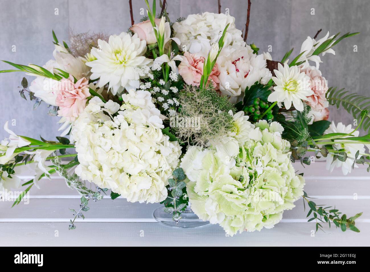 Wedding floral arrangement with hortensias (hydrangea), dahlias and ...