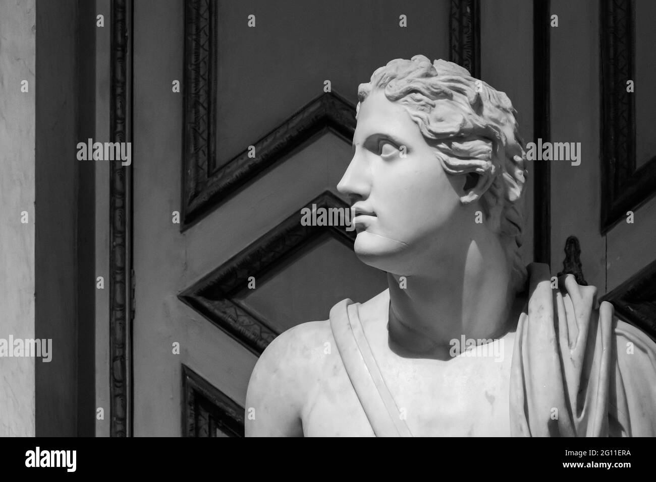 Close-up on face of ancient marble sculpture of a young handsome roman ...