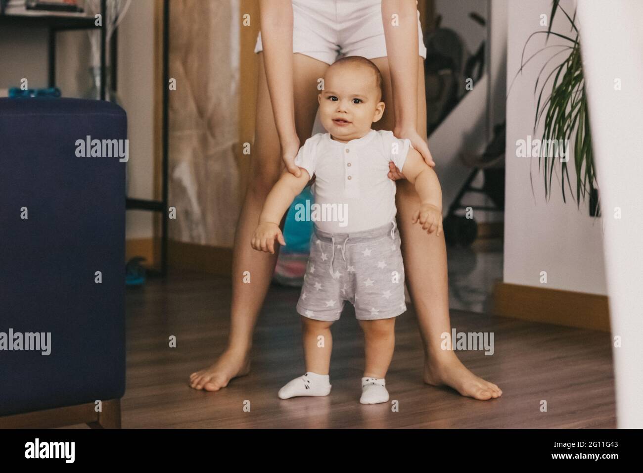 First steps of baby boy. Little child learning how to walk. Mother ... First steps of baby boy. Little child learning how to walk. Mother ...