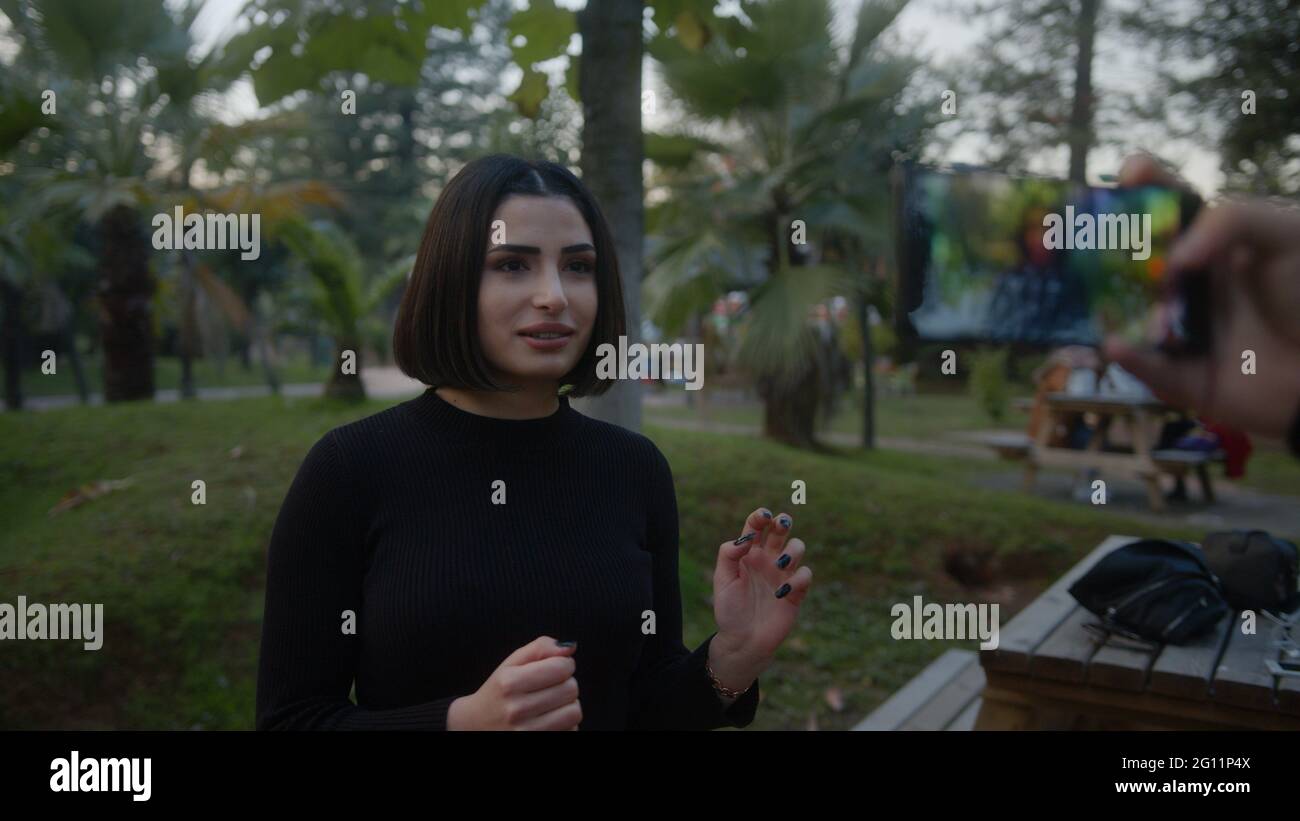 Beautiful smiling fashion blogger woman making online new video blog ...