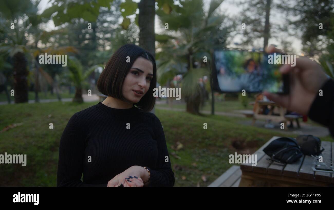 Beautiful smiling fashion blogger woman making online new video blog ...