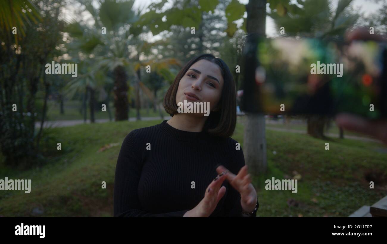 Beautiful smiling fashion blogger woman making online new video blog ...