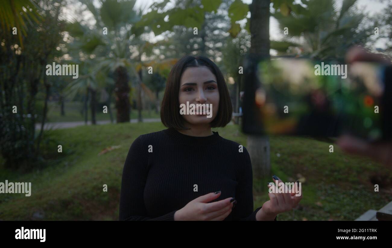 Beautiful smiling fashion blogger woman making online new video blog ...