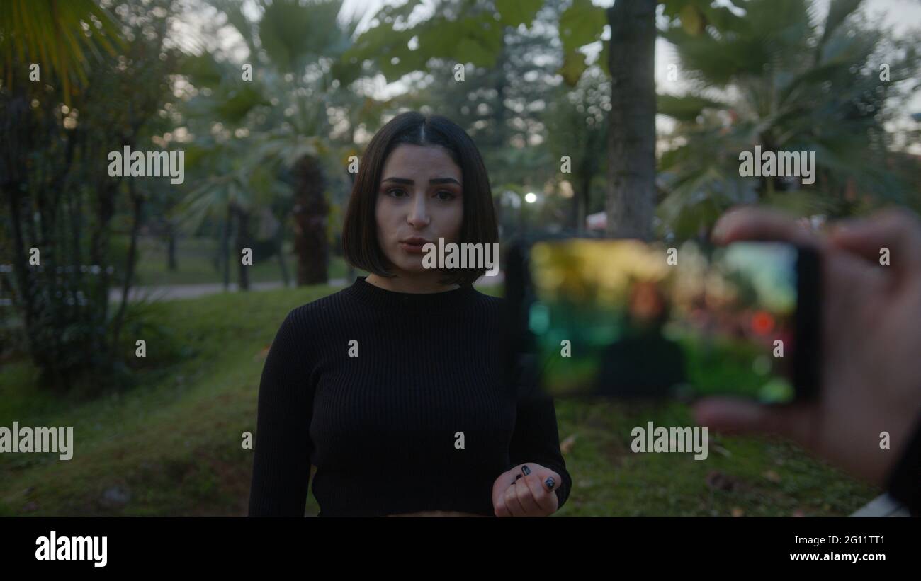 Beautiful smiling fashion blogger woman making online new video blog ...