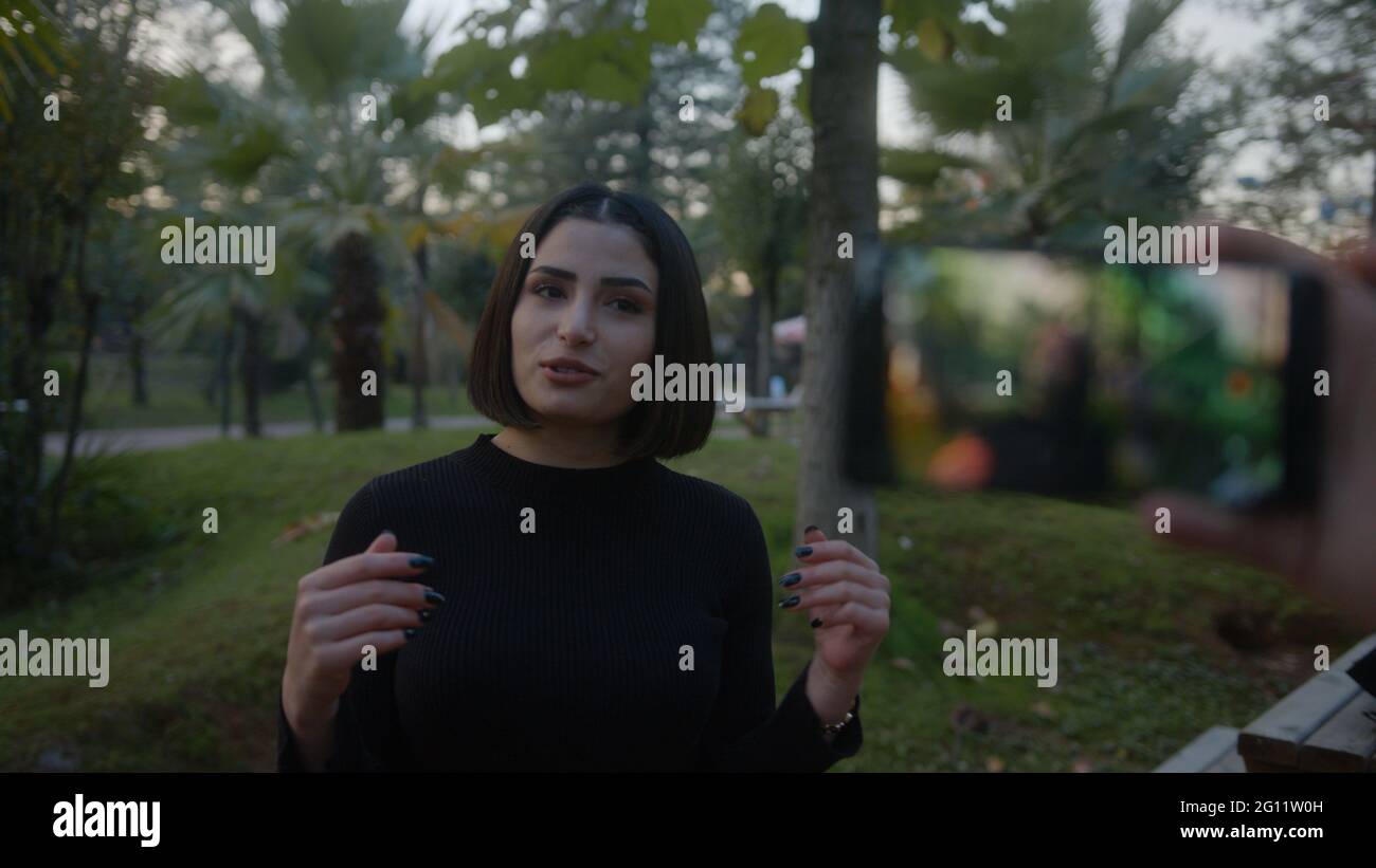 Beautiful smiling fashion blogger woman making online new video blog ...