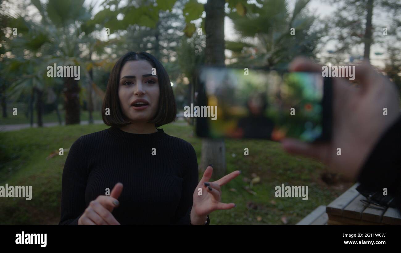 Beautiful smiling fashion blogger woman making online new video blog ...