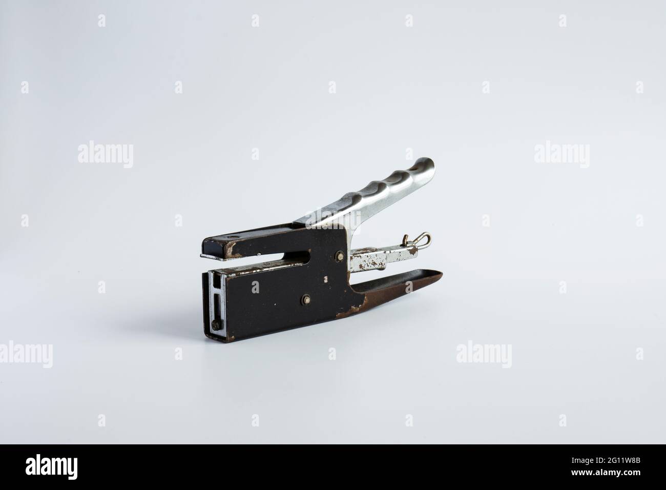vintage hand stapler on a white background Stock Photo - Alamy