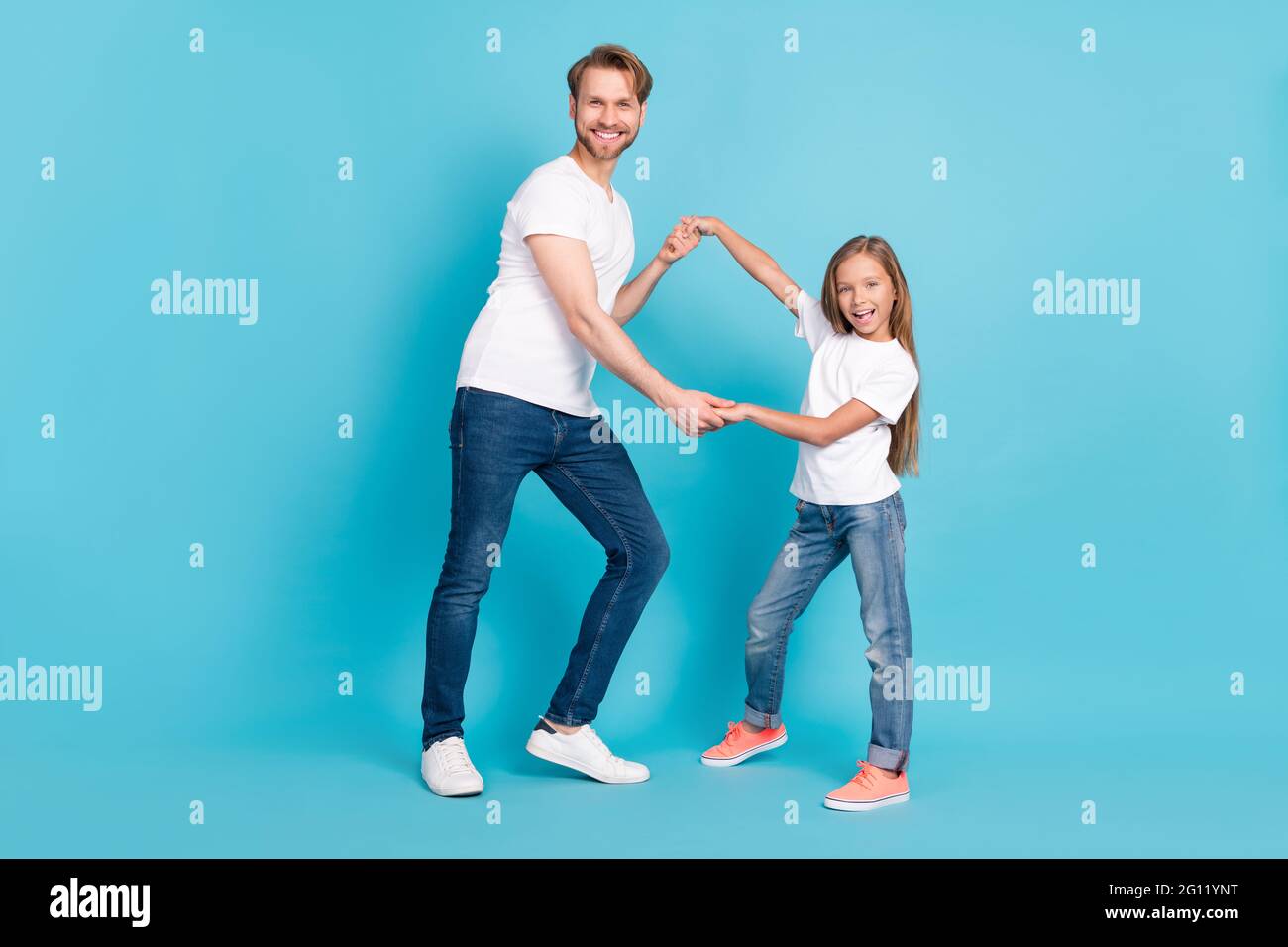 Full body portrait of two positive persons hold arms dancing look ...