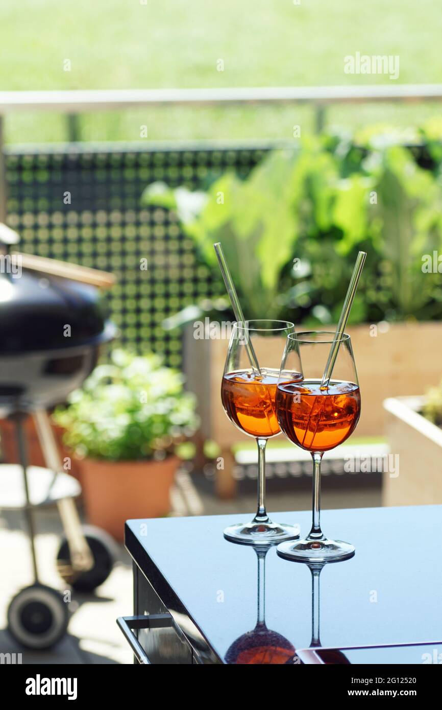 two summer apperitive drinks (venetian spritz, aperol) on a table on a ...