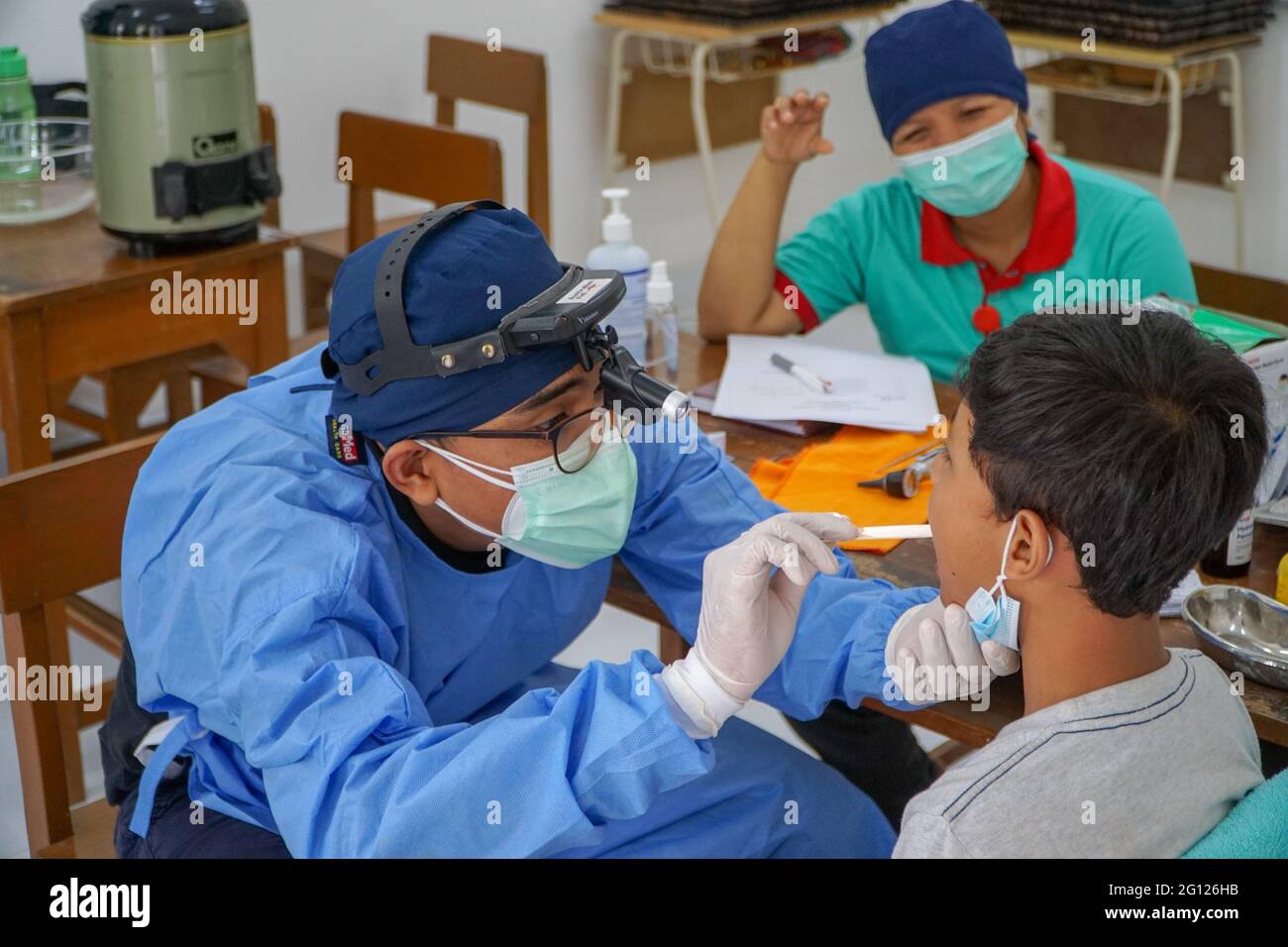 BALI/INDONESIA-MAY 28 2021: An ENT doctor is examining the ears, nose ...