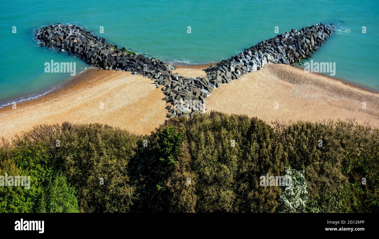 Sea defence rocks in a Y formation on Folkestone Beach Stock Photo - Alamy