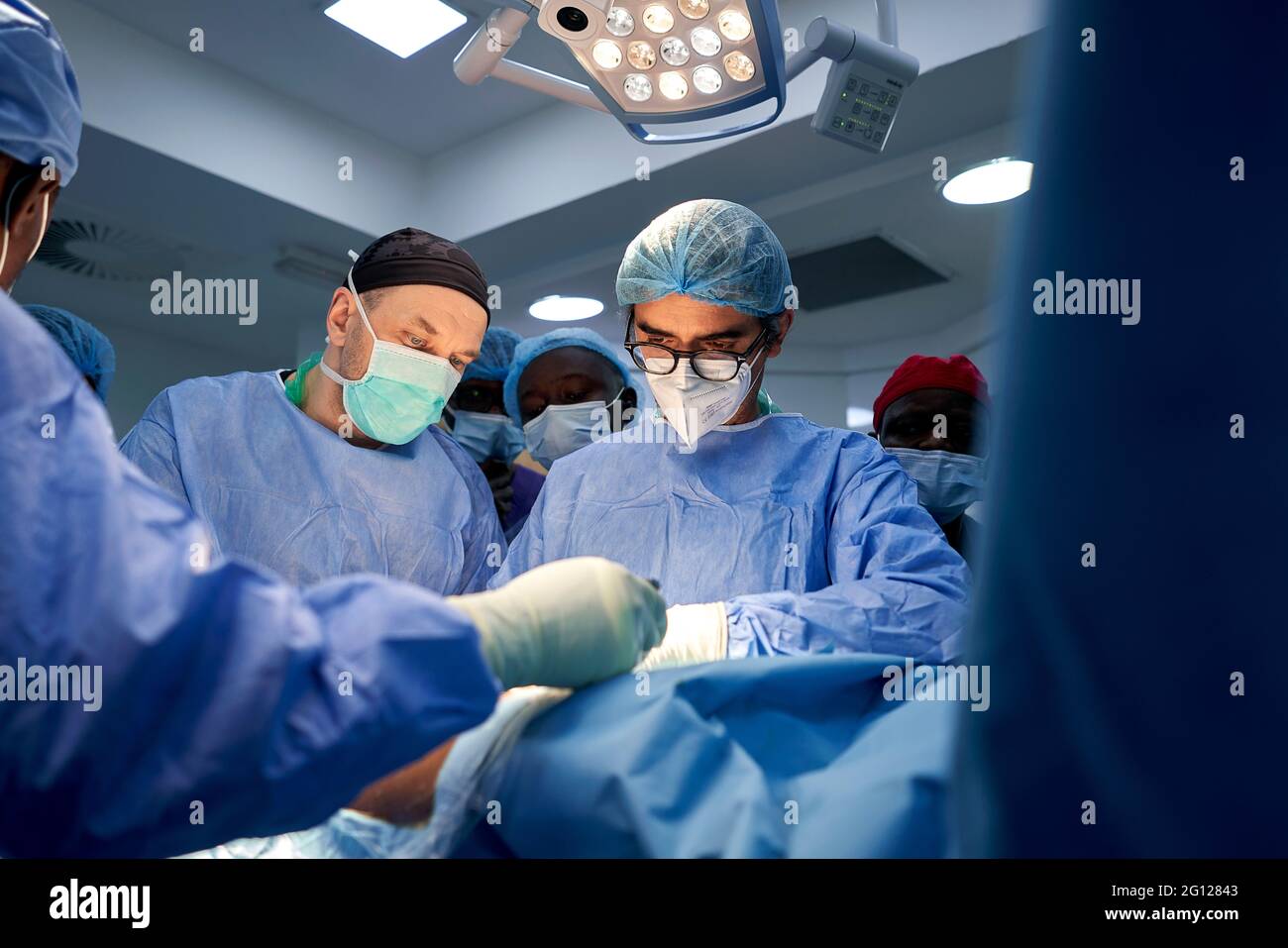 doctor and assistance Medical team performing surgery on a patient with ...