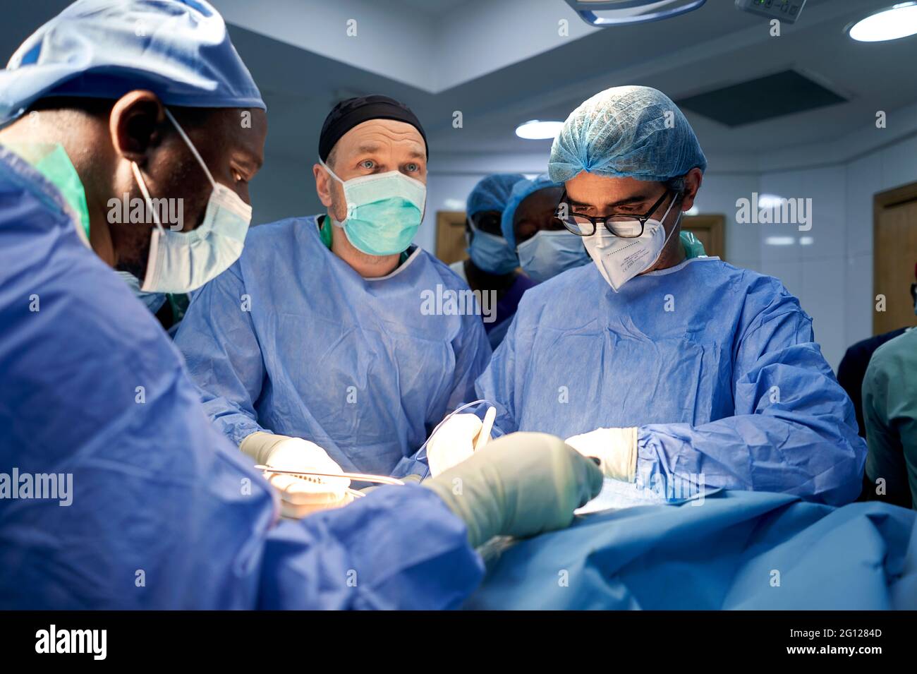 doctor and assistance Medical team performing surgery on a patient with ...