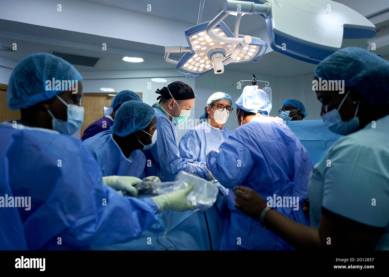 doctor and assistance Medical team performing surgery on a patient with ...
