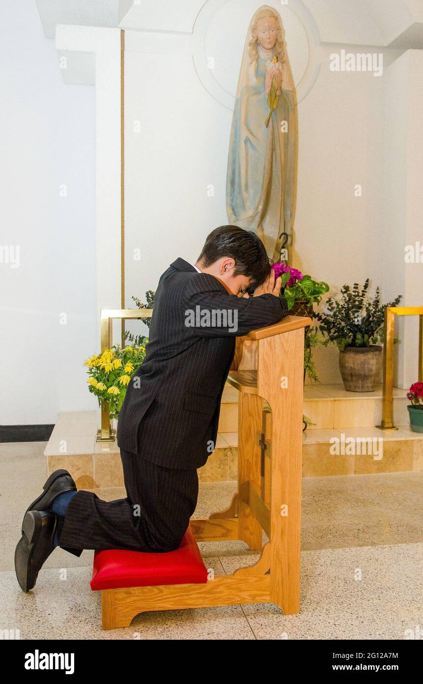 Child boy praying in a Catholic church (no release available Stock ...