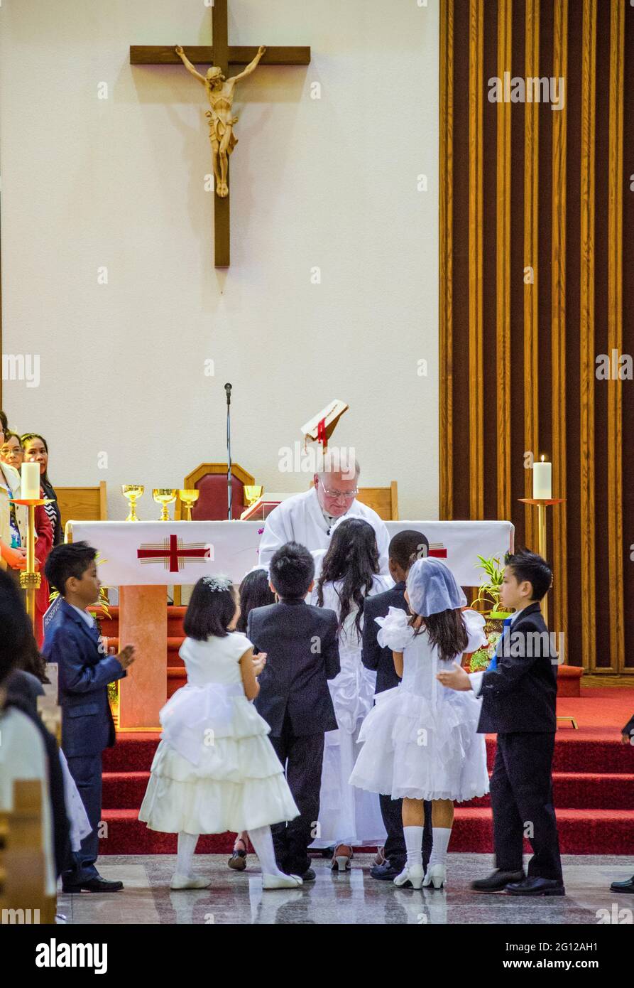 Catholic priest with children in First Communion event, Toronto, Canada ...