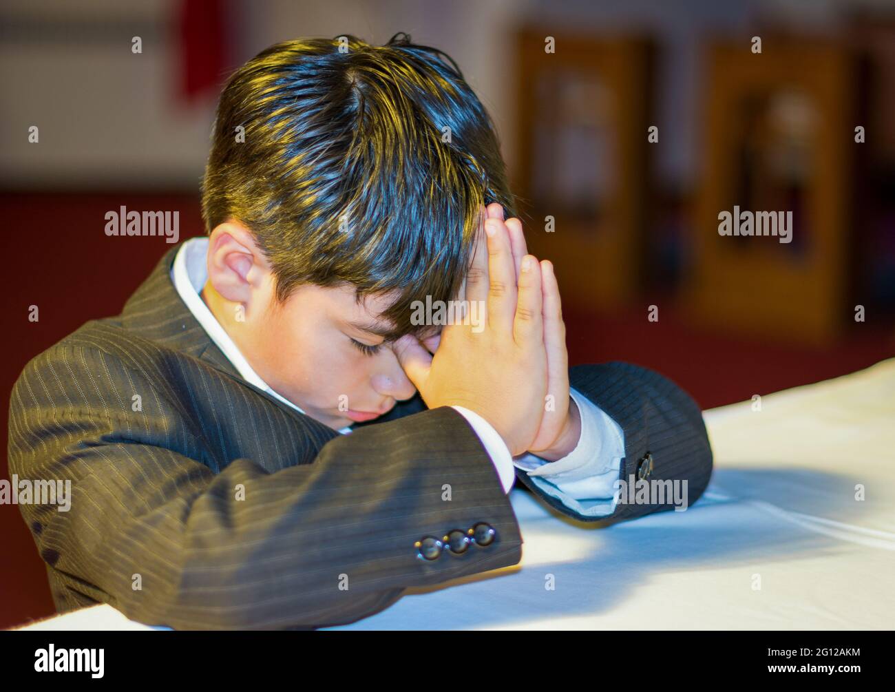 Hispanic child boy praying in hi-res stock photography and images - Alamy