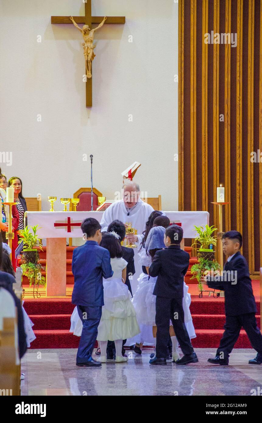 Catholic priest with children in First Communion event, Toronto, Canada ...