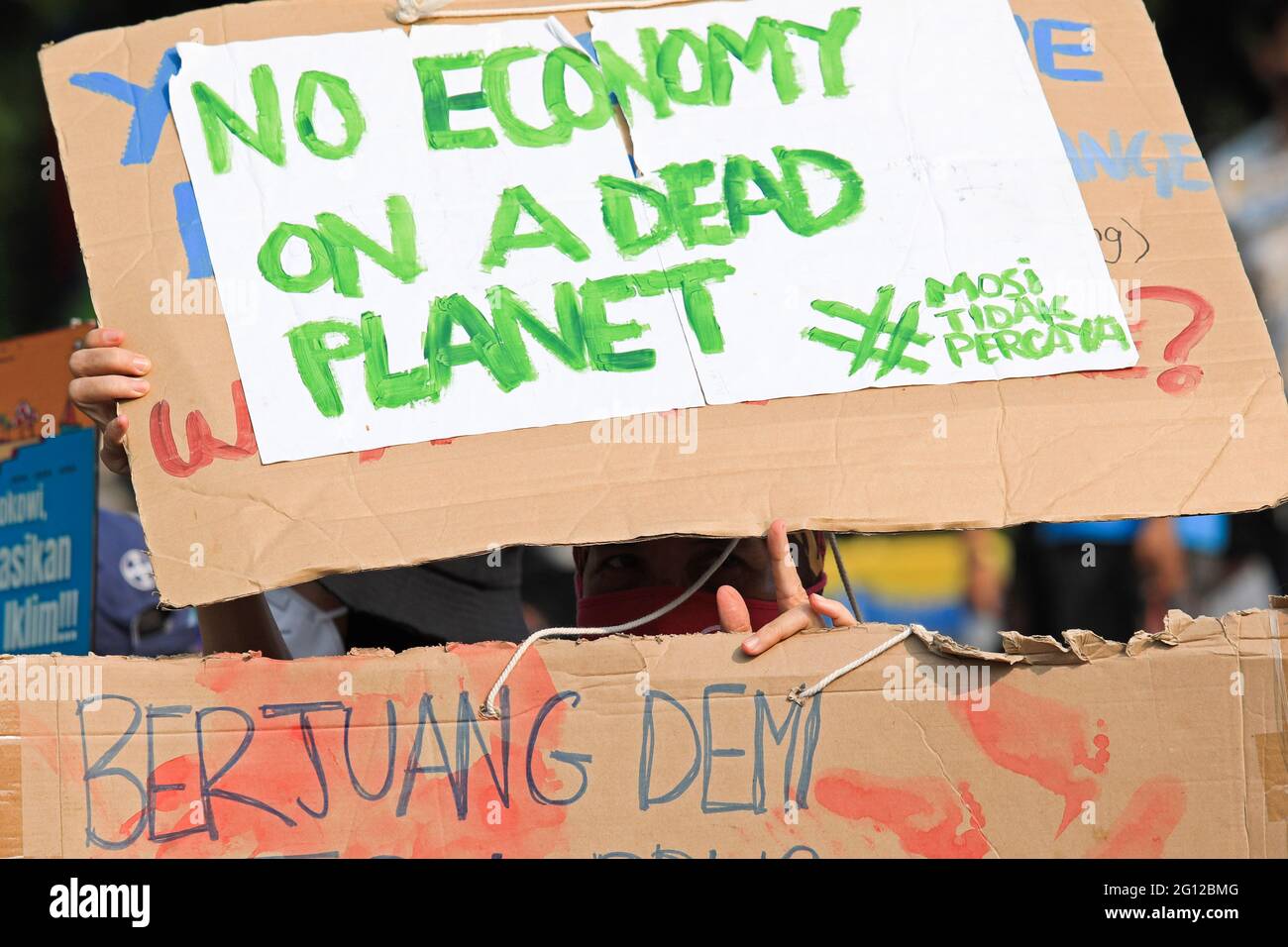 An activist holding placards expressing his opinion ahead of World Environment Day. World ...