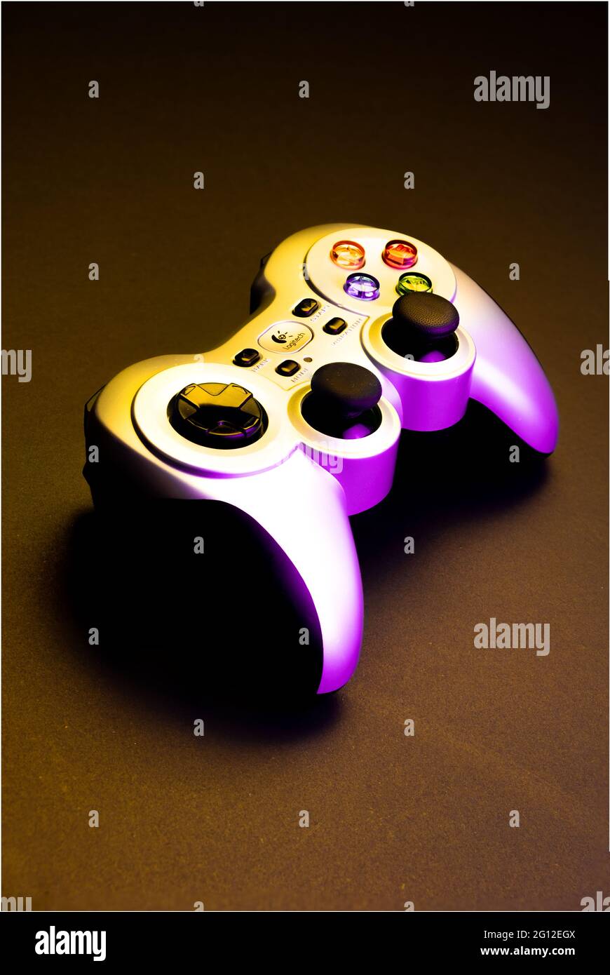 Game console control on a multi-colored illuminated background ...