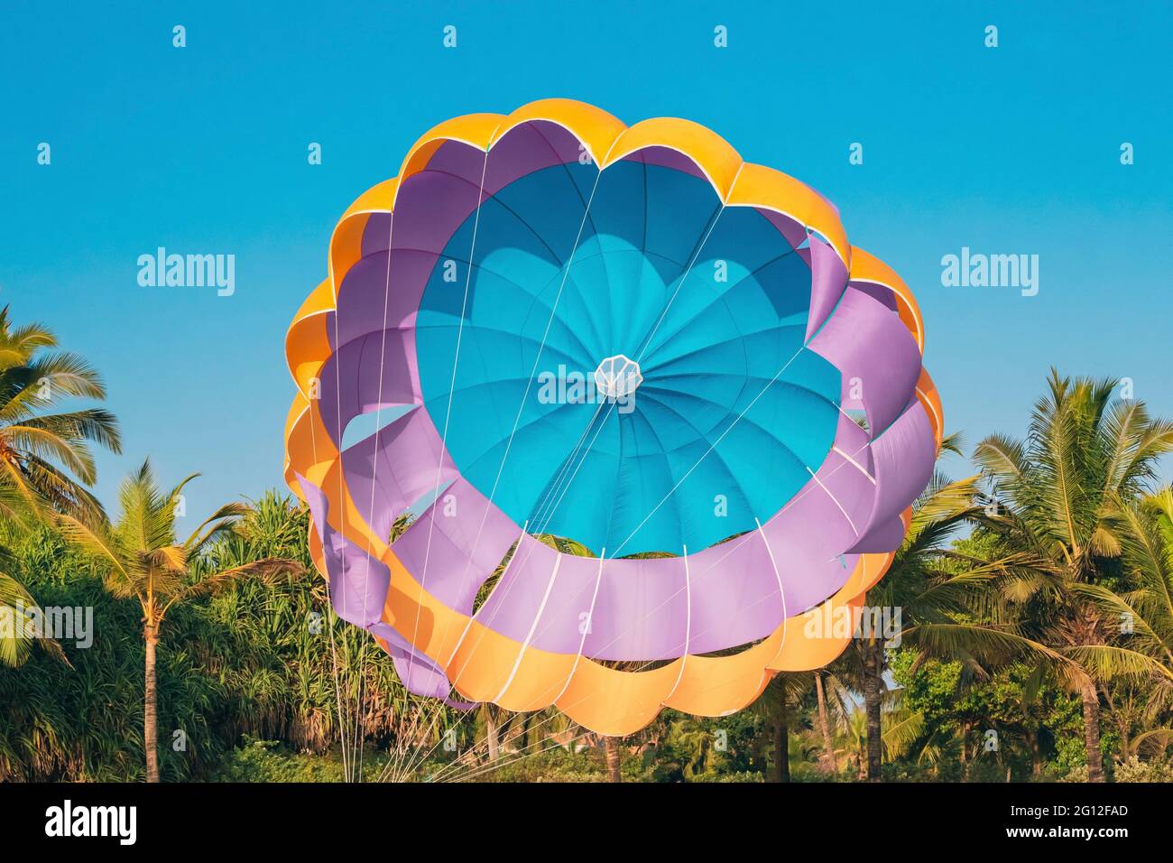Multi-colored Parachute For Parasailing On Background Of Palm Trees And ...