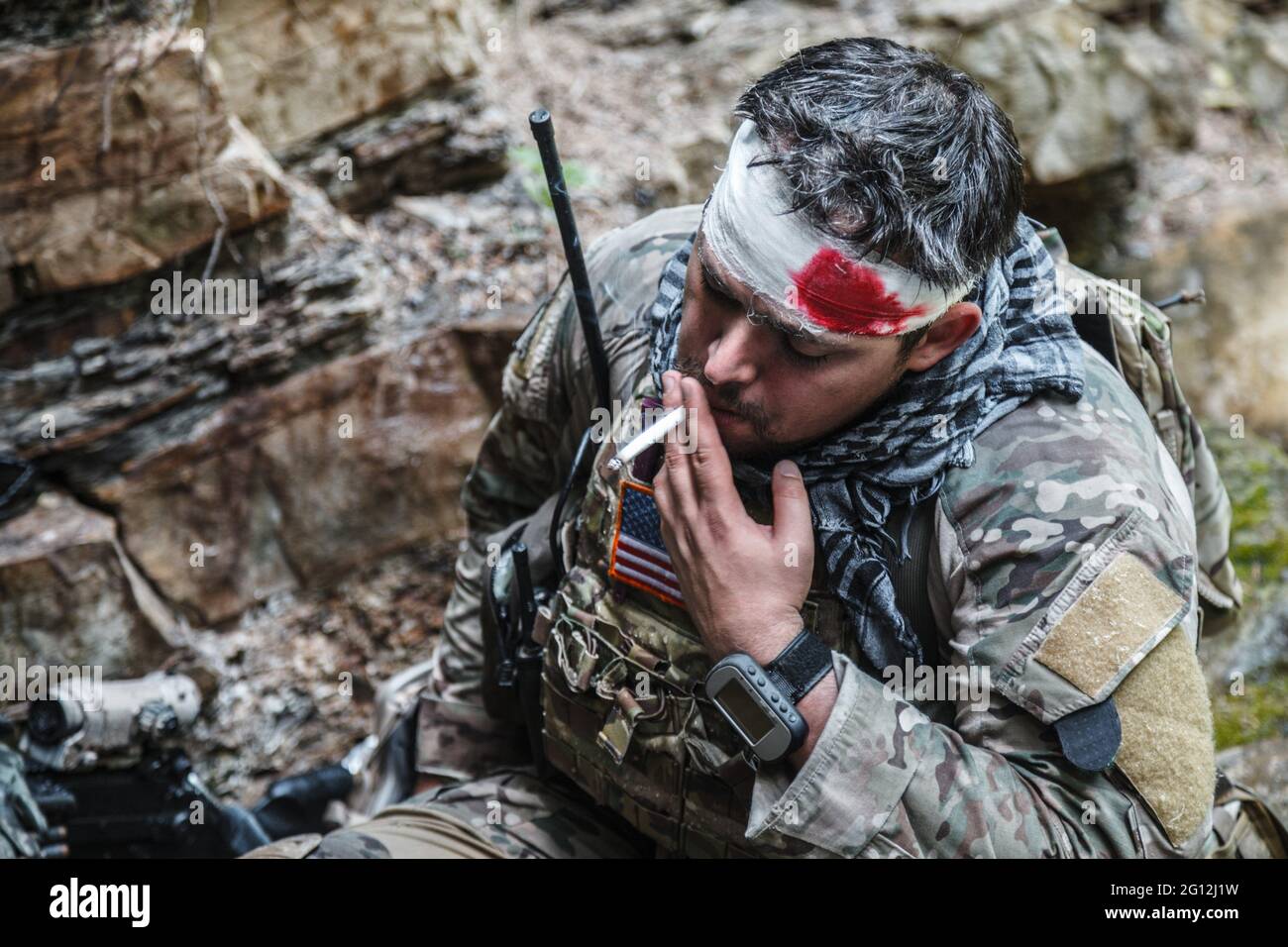 Wounded army ranger machine gunner in the mountains Stock Photo - Alamy
