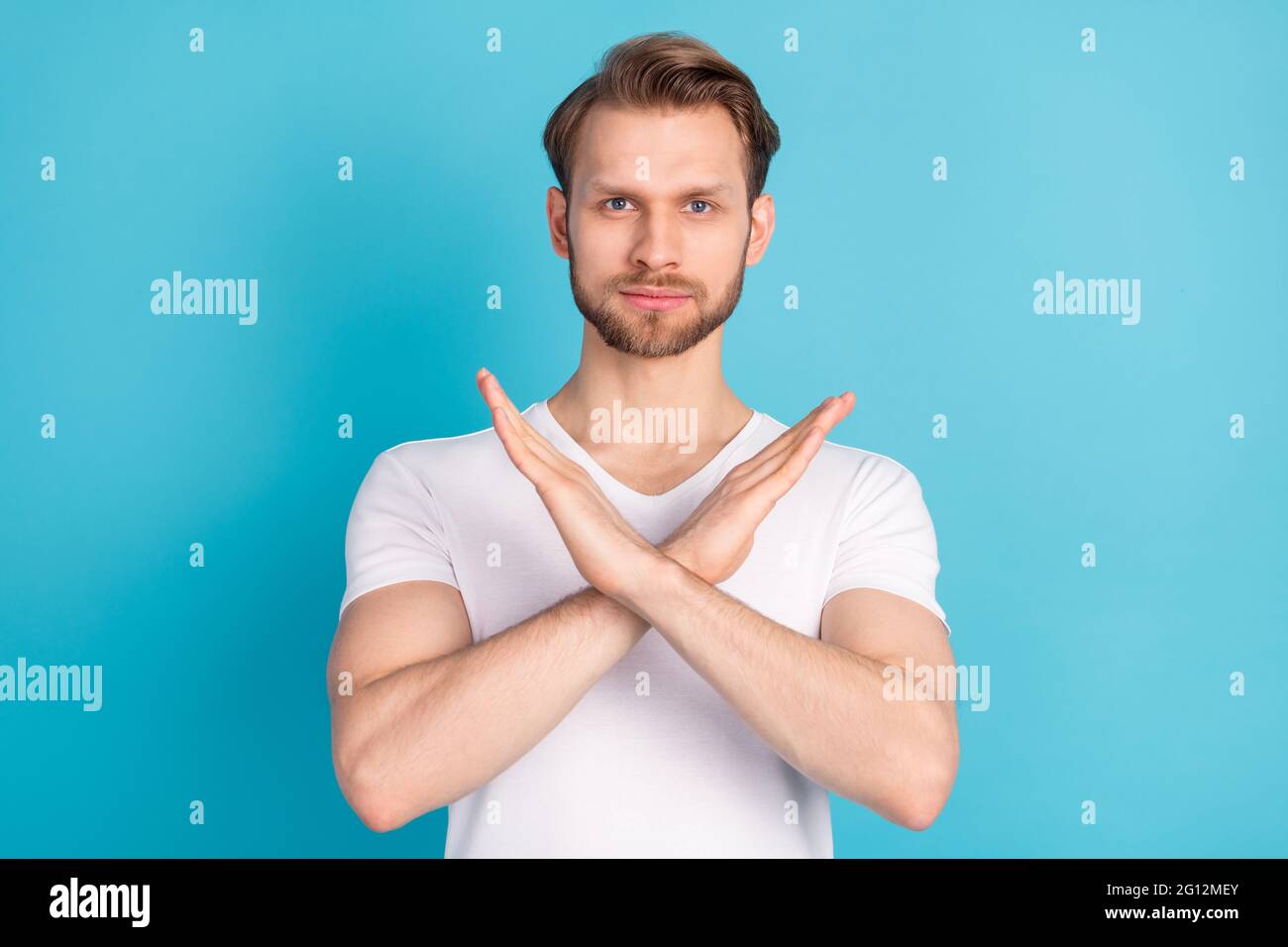 Portrait of focused young person crossed arms show stop symbol look ...