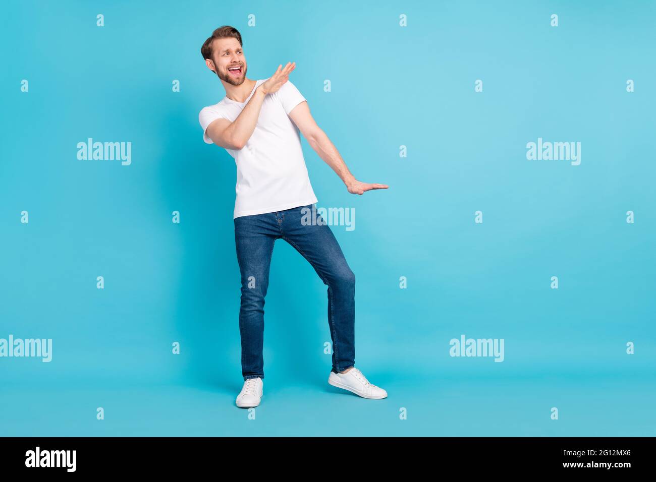 Full body photo of crazy excited cheerful man look empty space partying ...
