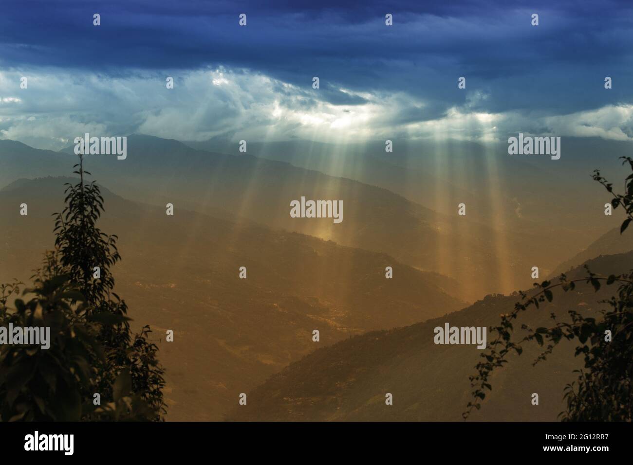 Sun rays coming out of cloud burst - at Rabangla, Sikkim, India. Trees ...