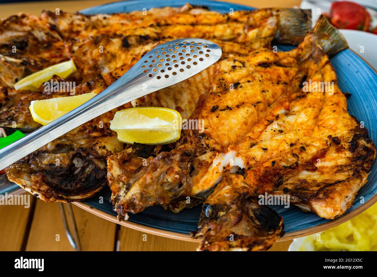 European bass fish grilled and served on a plate Stock Photo - Alamy