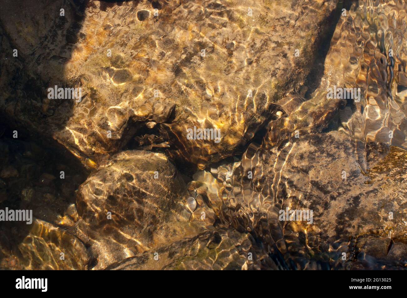 Sunrays reflecting from stones and rocks underwater - creating ...