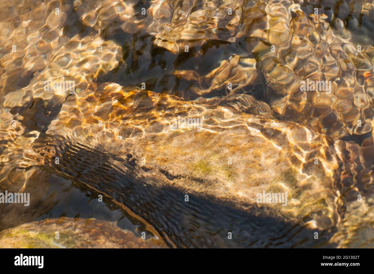 Sunrays reflecting from stones and rocks underwater - creating ...