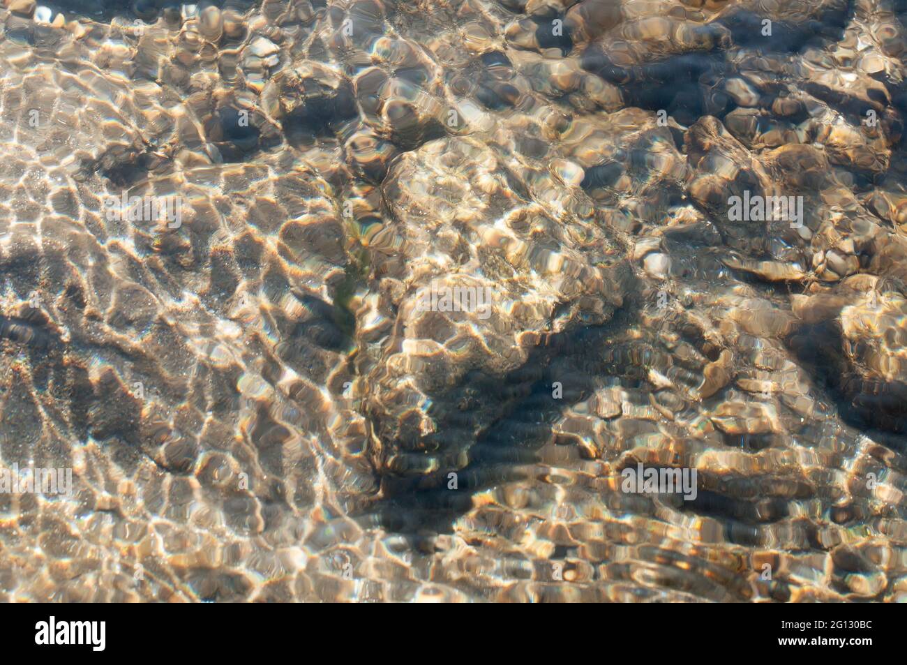 Sunrays reflecting from stones and rocks underwater - creating ...