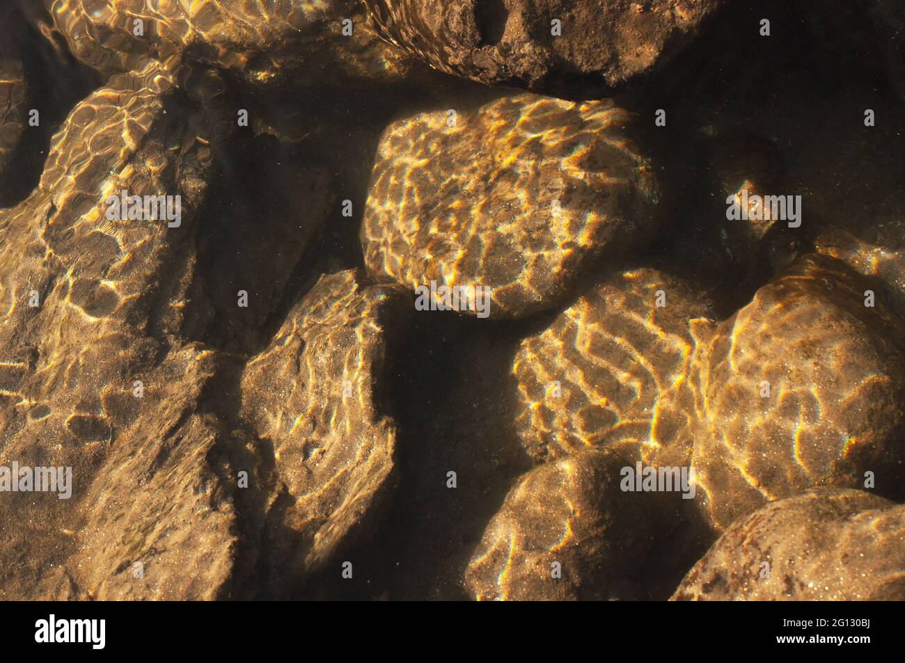 Sunrays reflecting from stones and rocks underwater - creating ...
