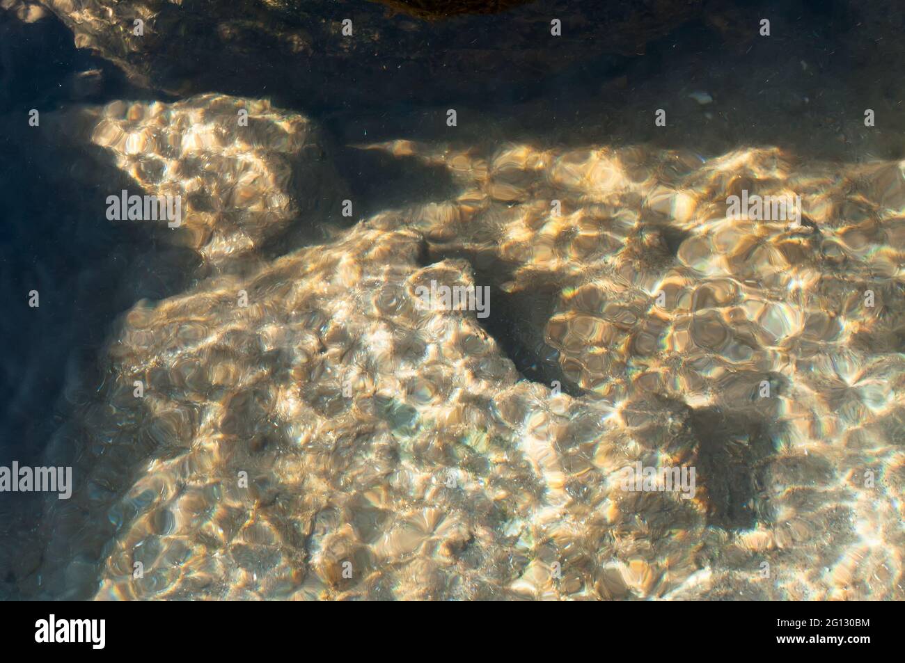 Sunrays reflecting from stones and rocks underwater - creating ...