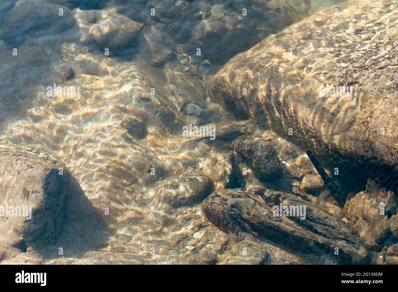 Sunrays reflecting from stones and rocks underwater - creating ...