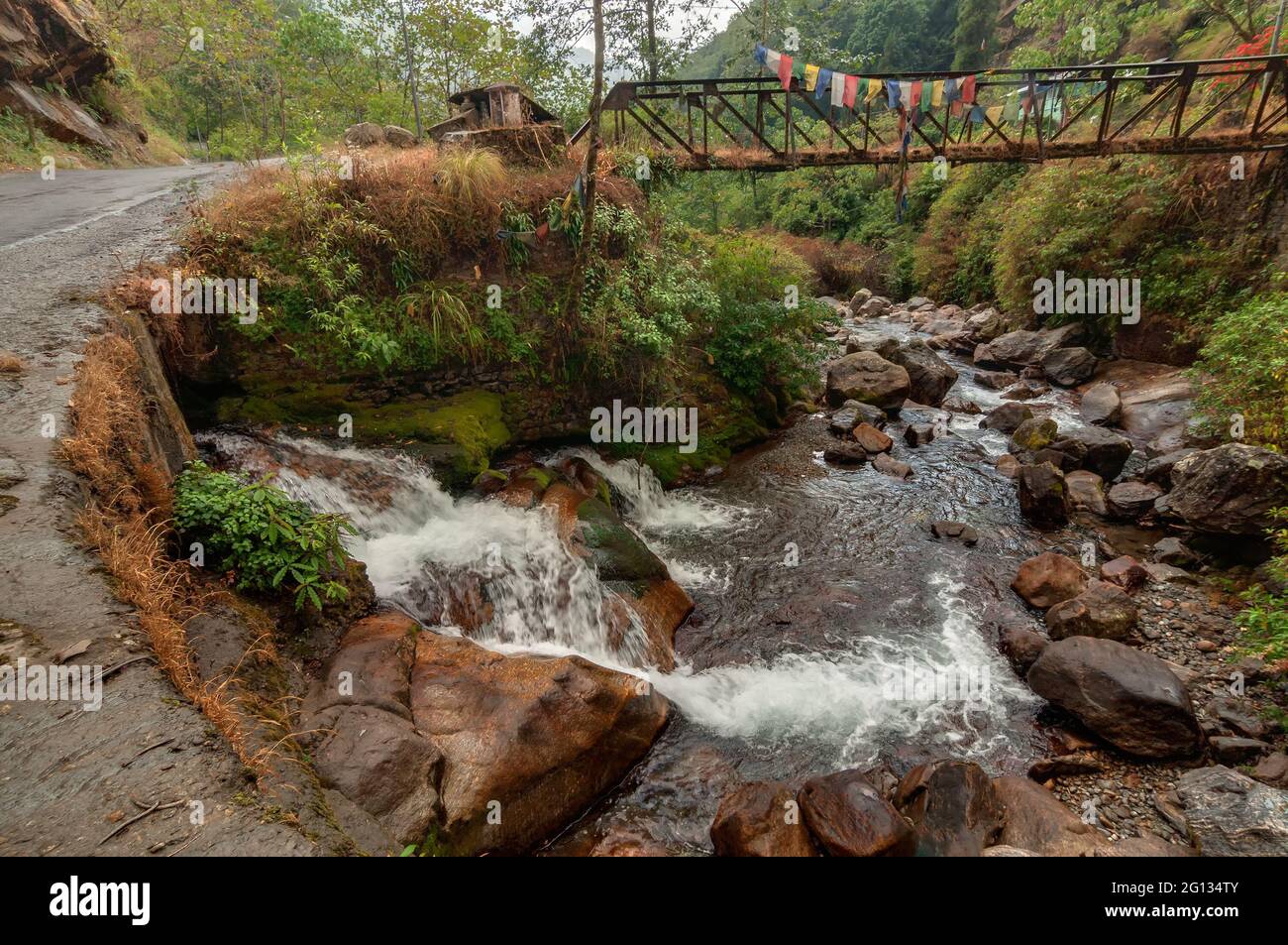 Fountain water flowing through rocks with green plants around, Kukhola ...
