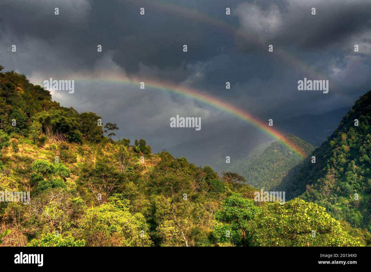 Beautiful rainbow on cloudy sky over Himalayan mountains at Sikkim ...