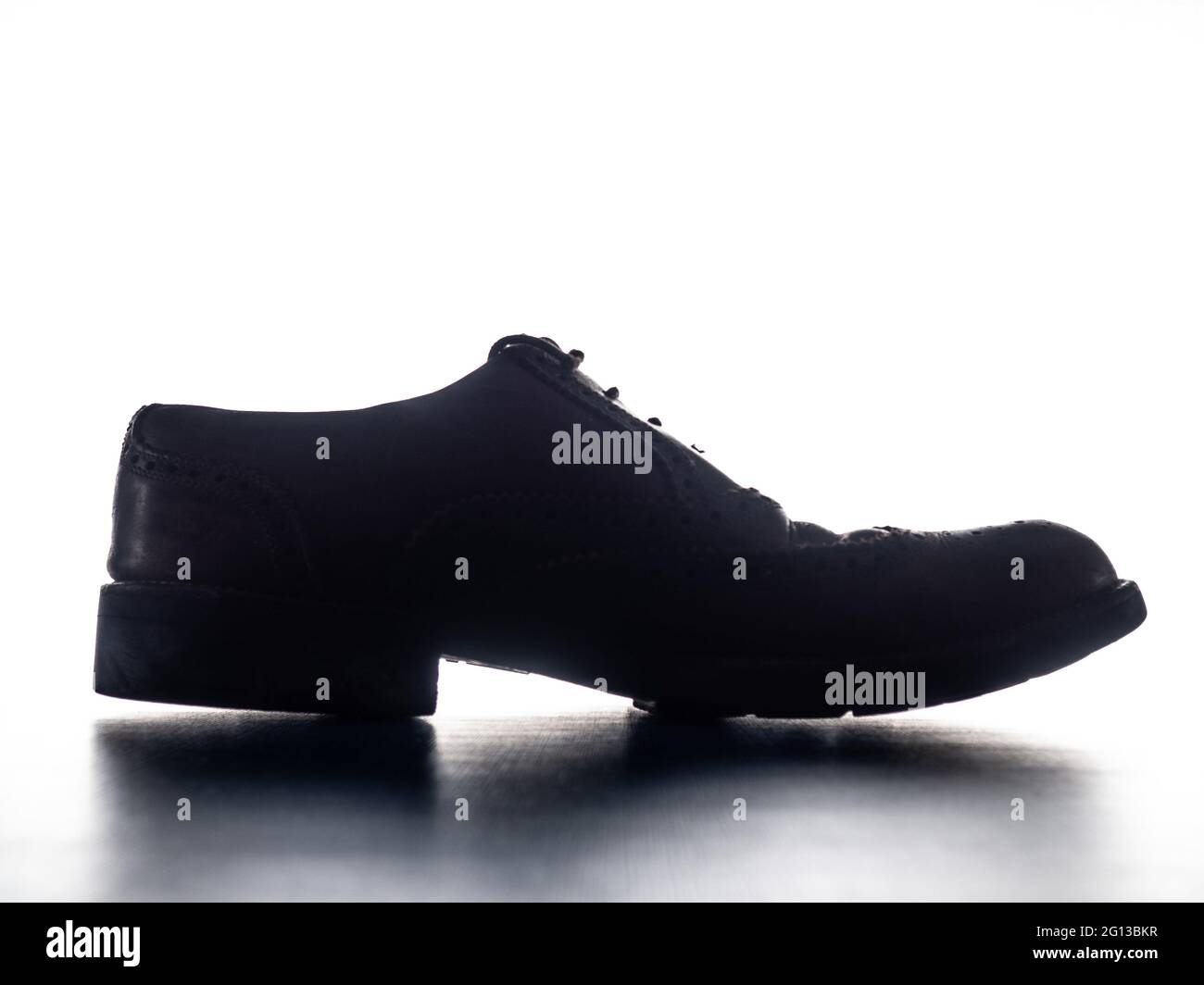Men left shoe silhouette on the floor against a white background Stock ...