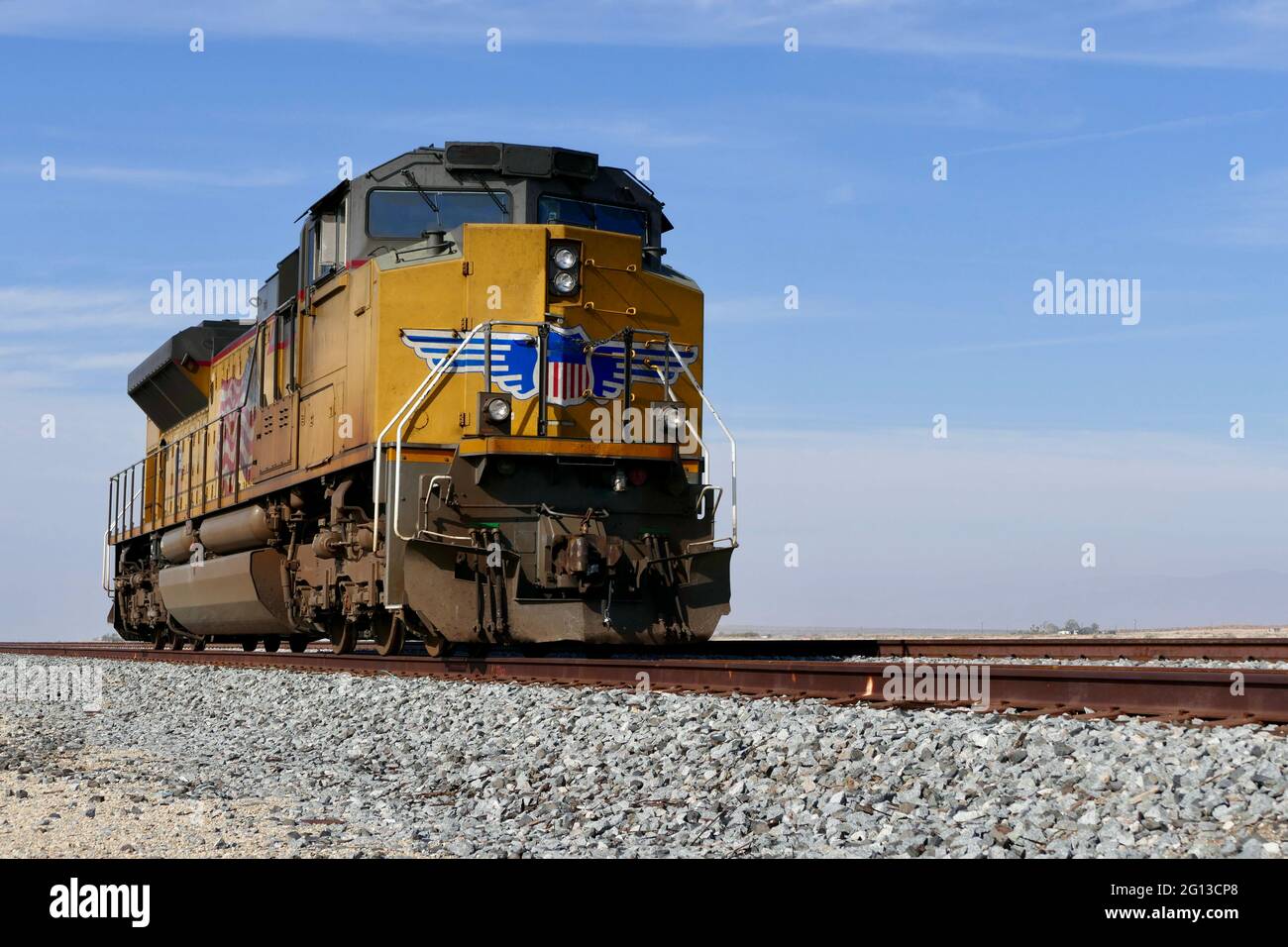 closeup of locomotive on train tracks in the desert Stock Photo - Alamy