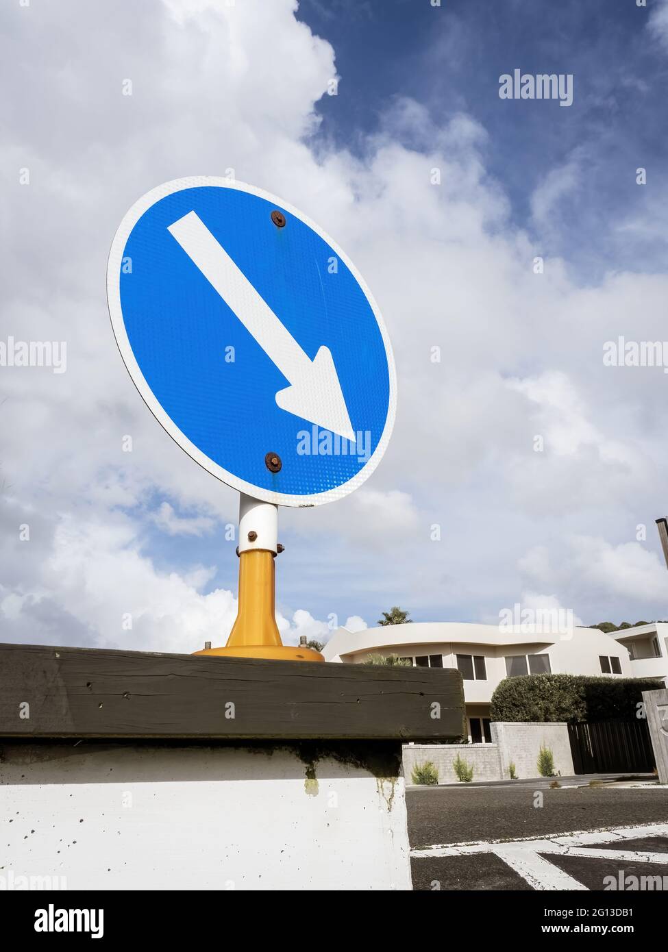 Keep right blue compulsory road sign with white arrow Stock Photo - Alamy
