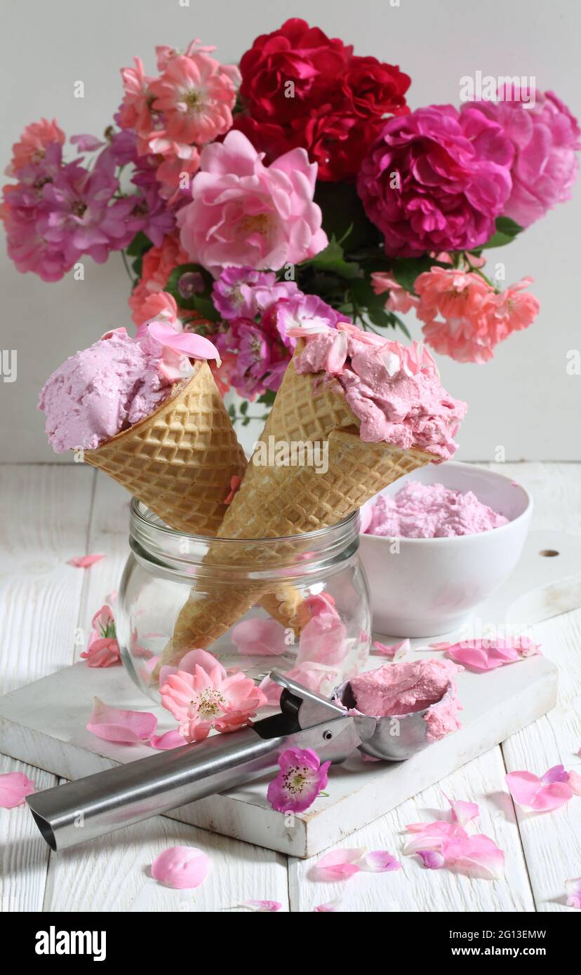 Still life with fruit ice cream and a bouquet of roses on a white ...