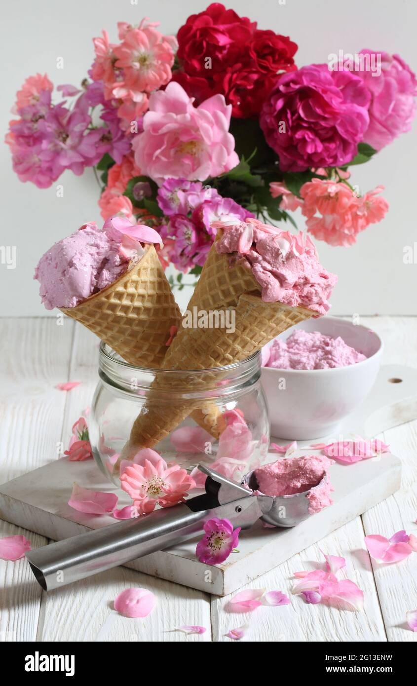 Still life with fruit ice cream and a bouquet of roses on a white ...