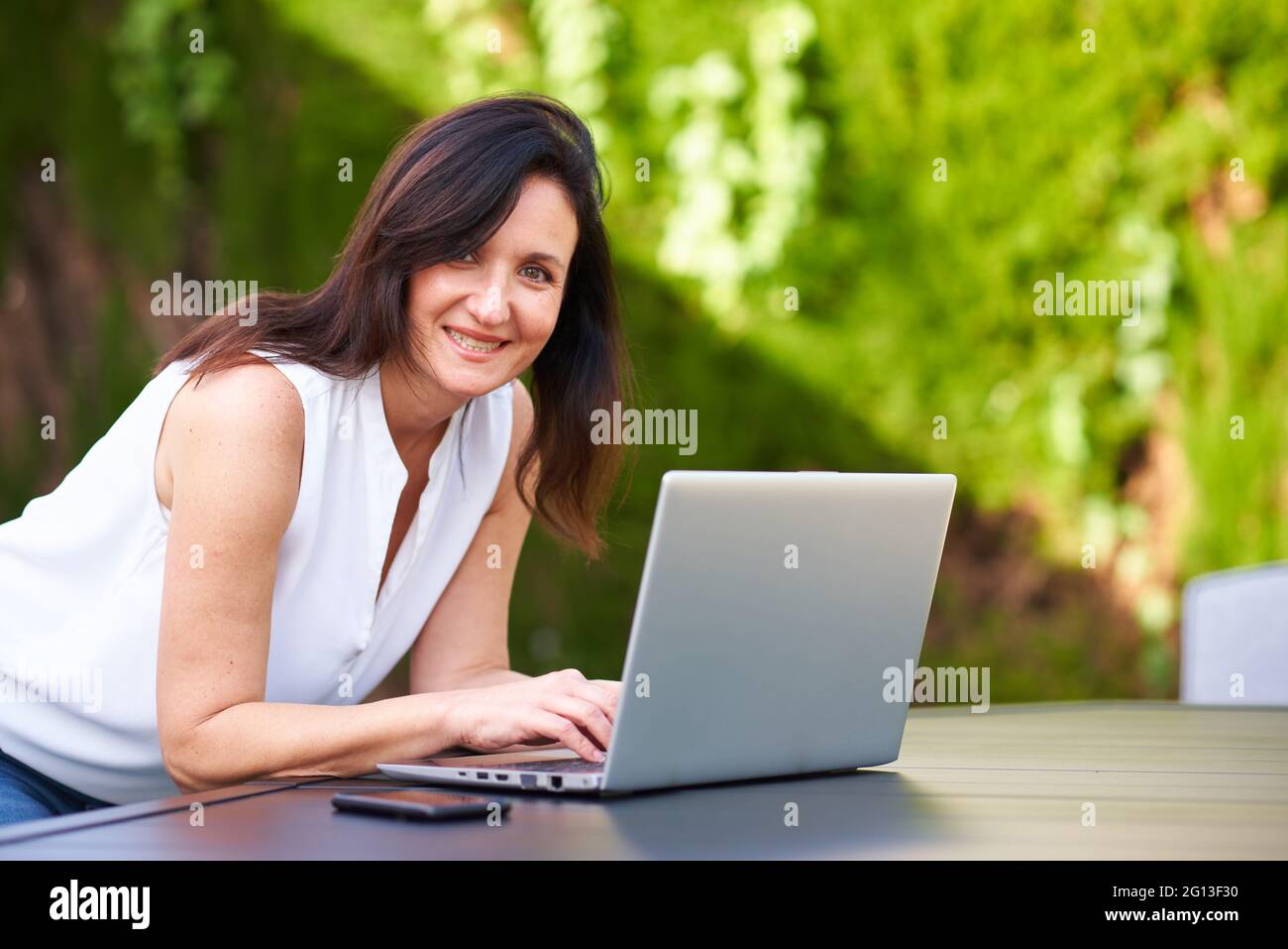 Girl smiling on the laptop while typing hi-res stock photography and ...
