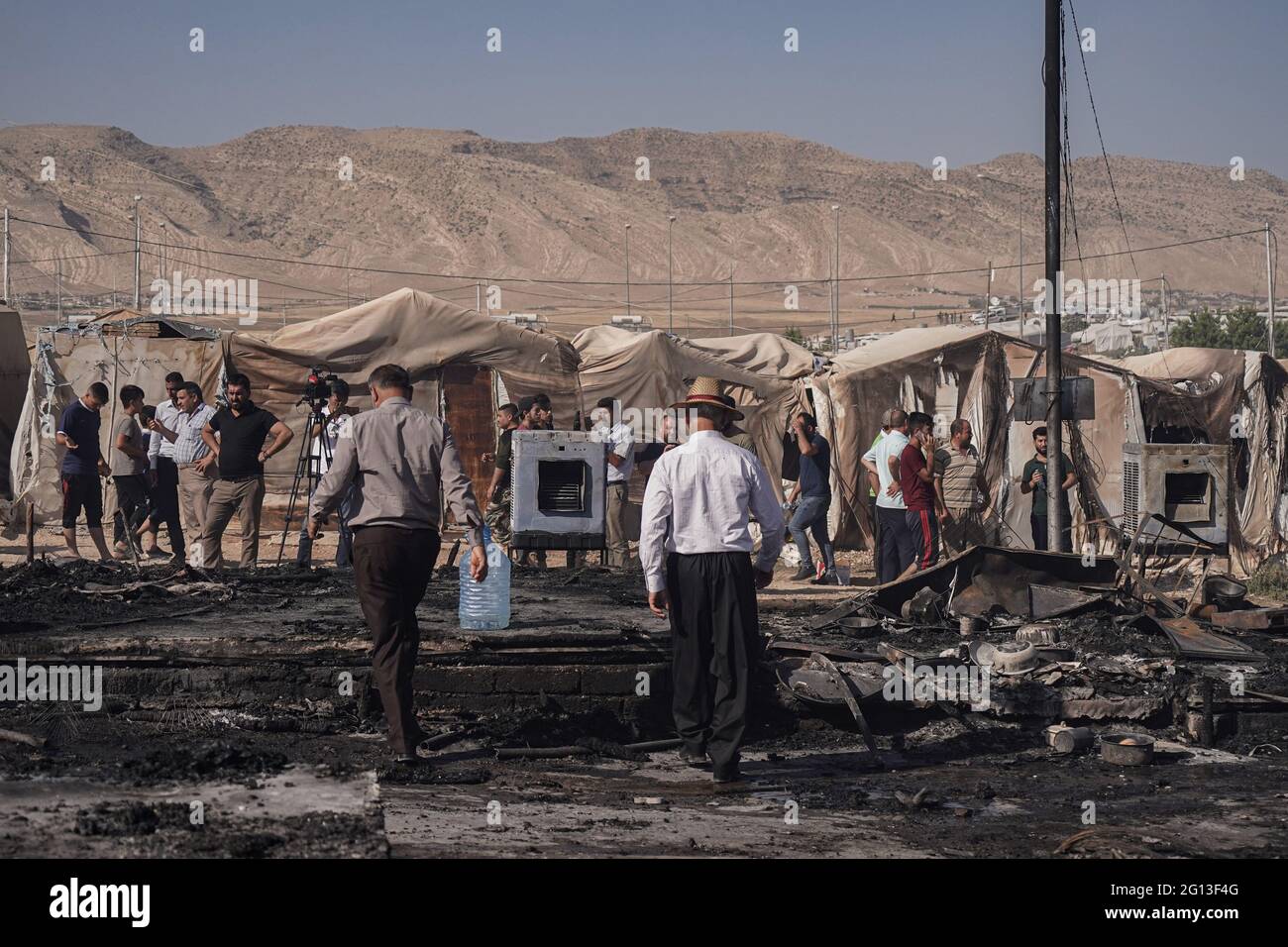 Sharya, Iraq. 04th June, 2021. People inspect their scorched tents ...