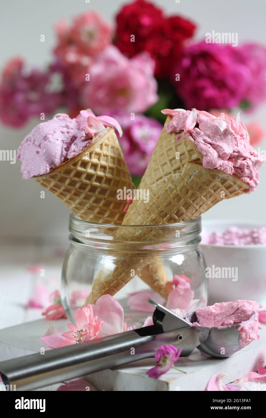 Still life with fruit ice cream and a bouquet of roses on a white ...